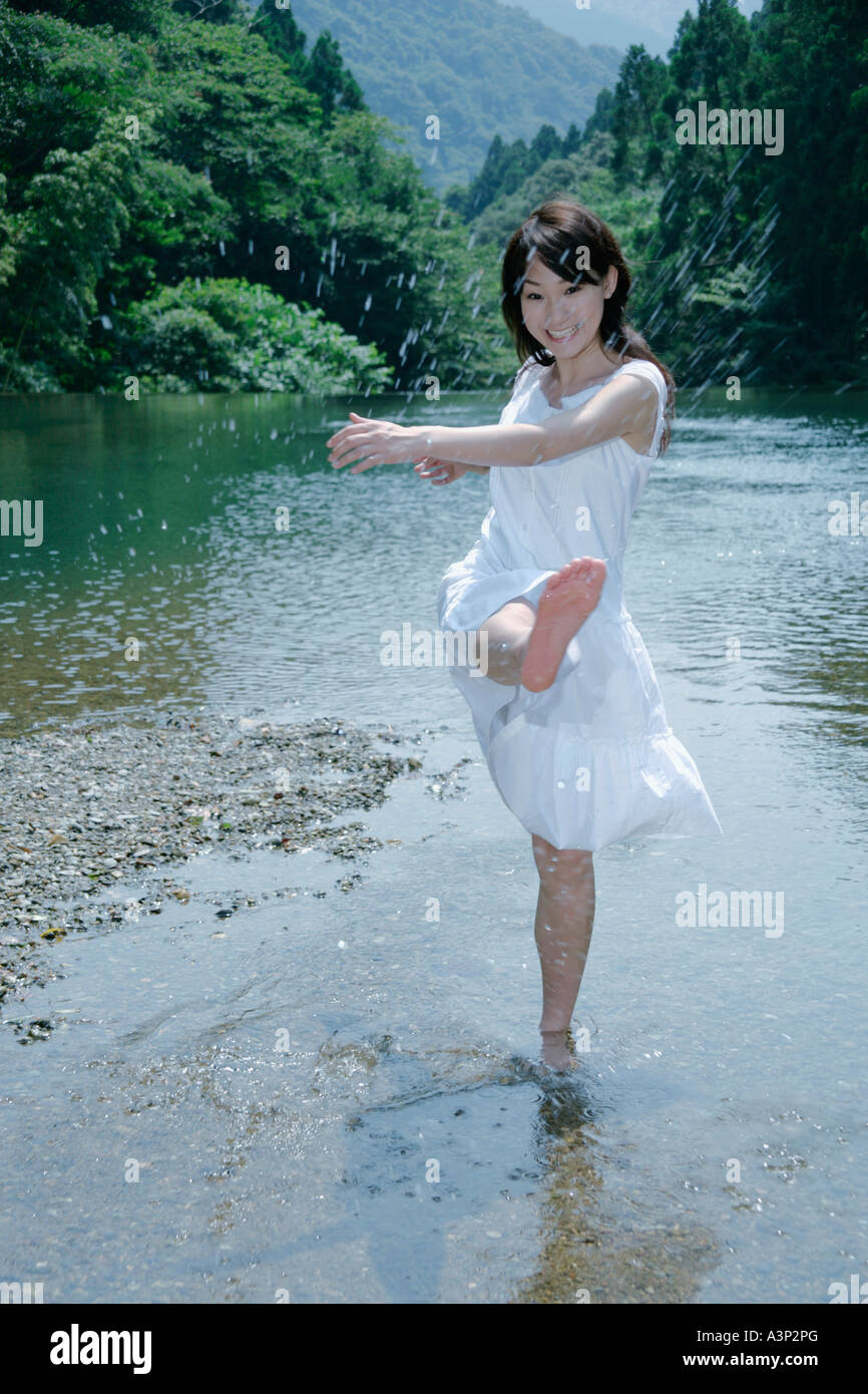 A young woman splashing water Stock Photo - Alamy