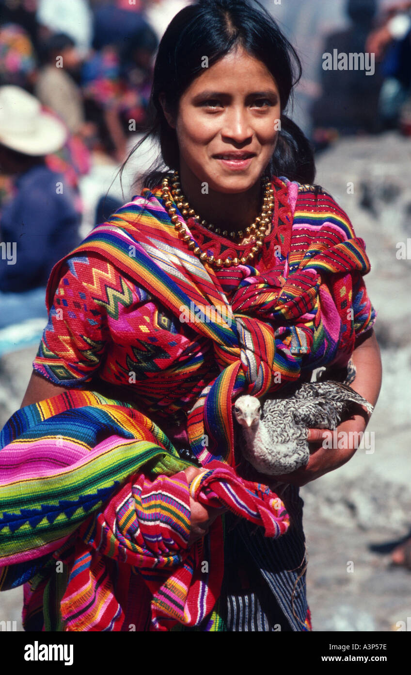 Woman carrying chicken, smiling, portrait Stock Photo - Alamy