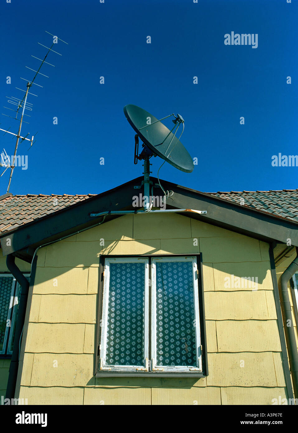 a house with television satellit on the roof Stock Photo - Alamy
