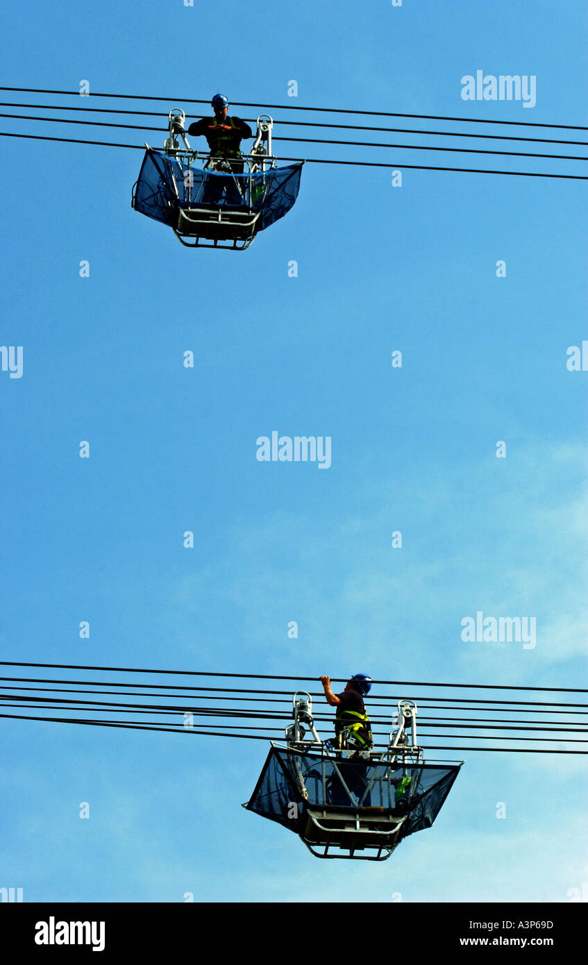 Electricity workers working on power lines Stock Photo - Alamy