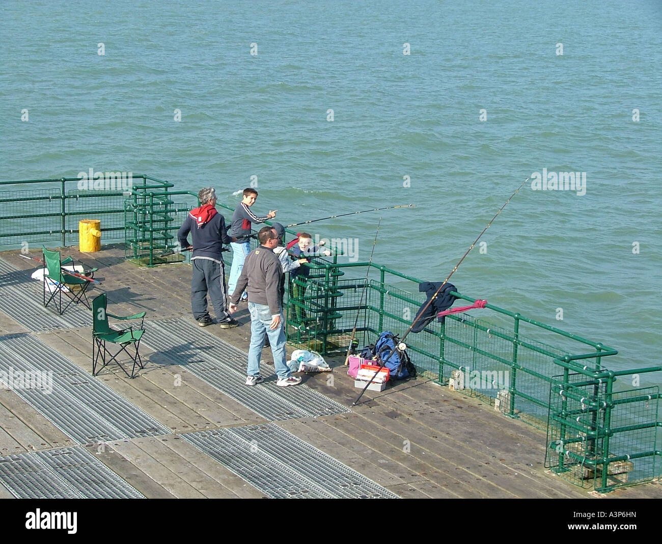 Family fishing from Deal pier, Kent Stock Photo - Alamy