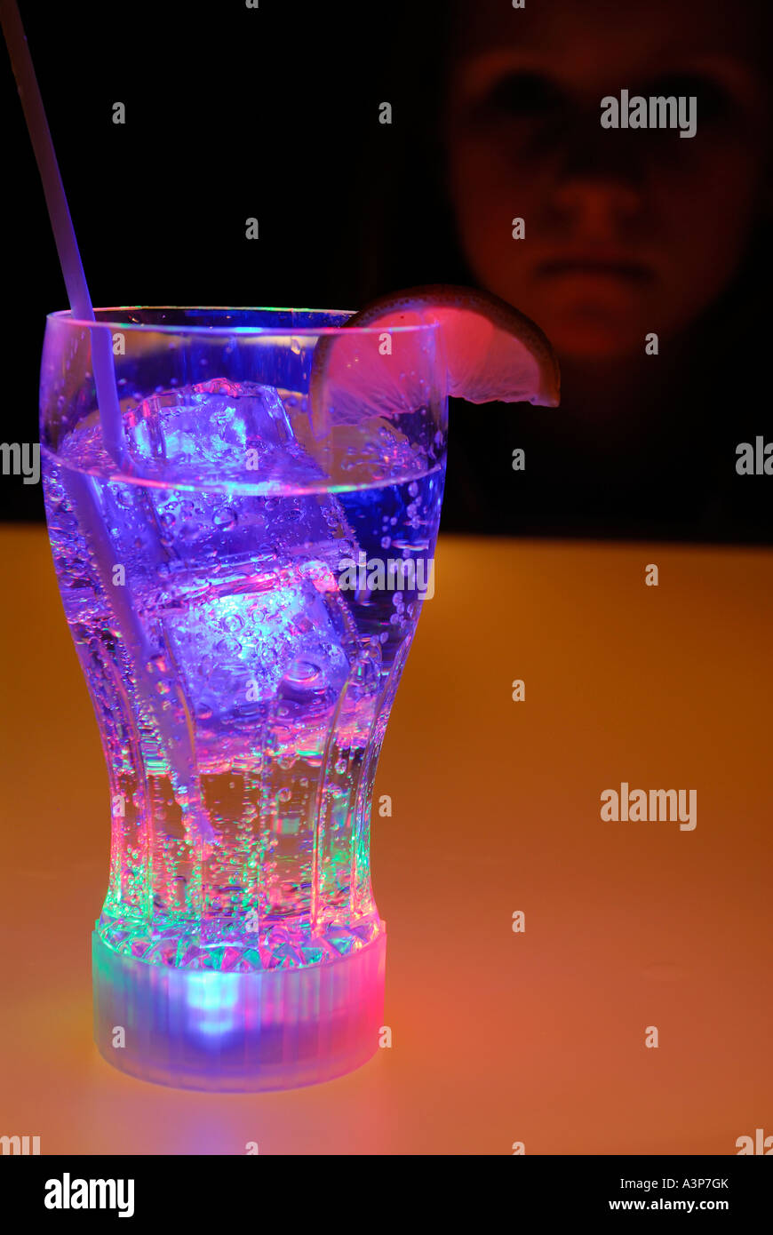 Women waiting for her Sparkling clear alcoholic beverage lit with ...