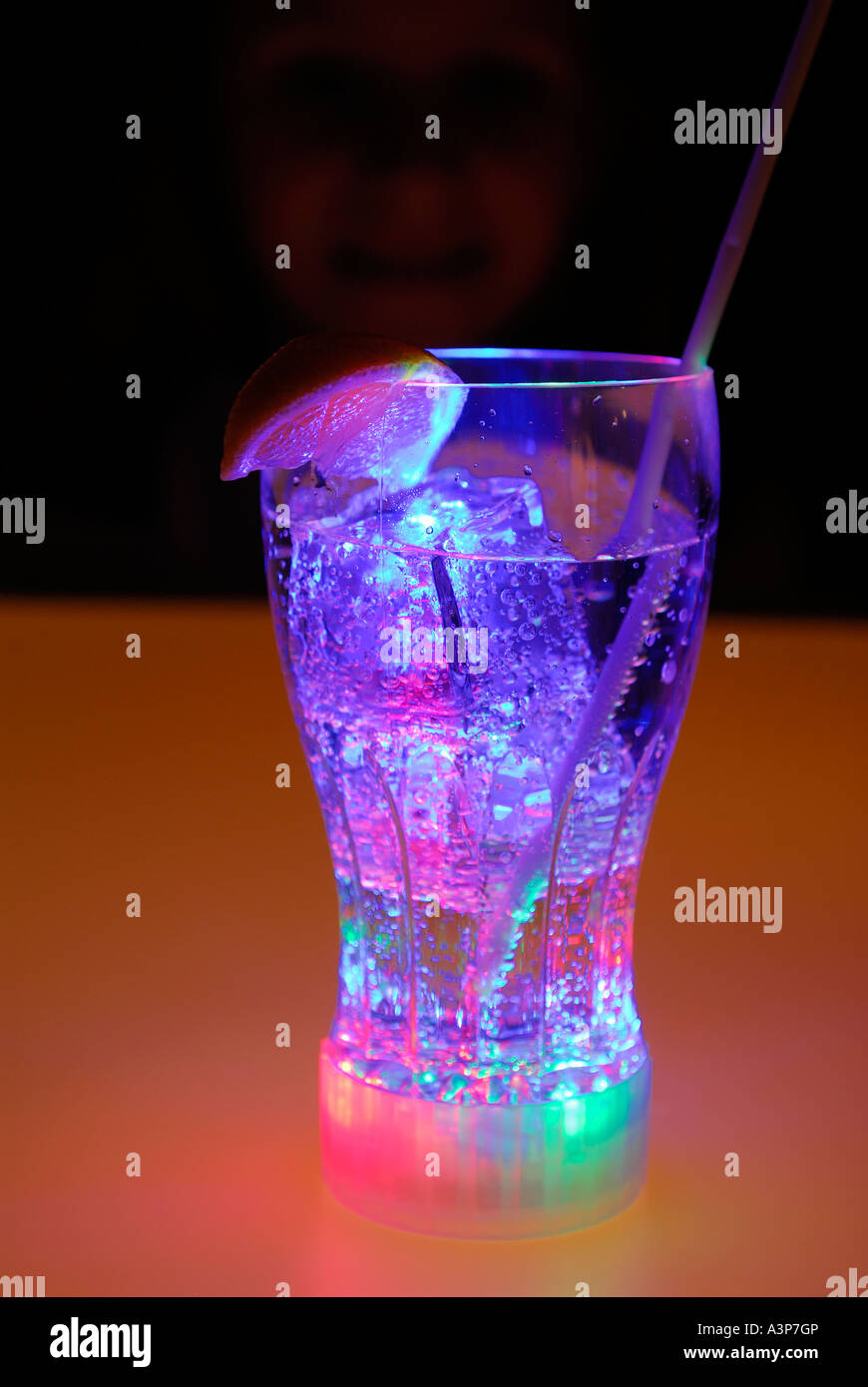 Sparkling clear beverage lit with colored lights Stock Photo - Alamy