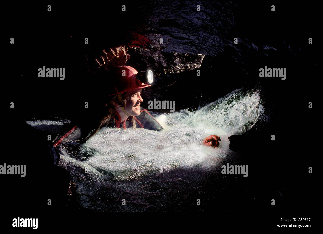 Female caver crawling in water in a South Wales cave UK Stock Photo - Alamy