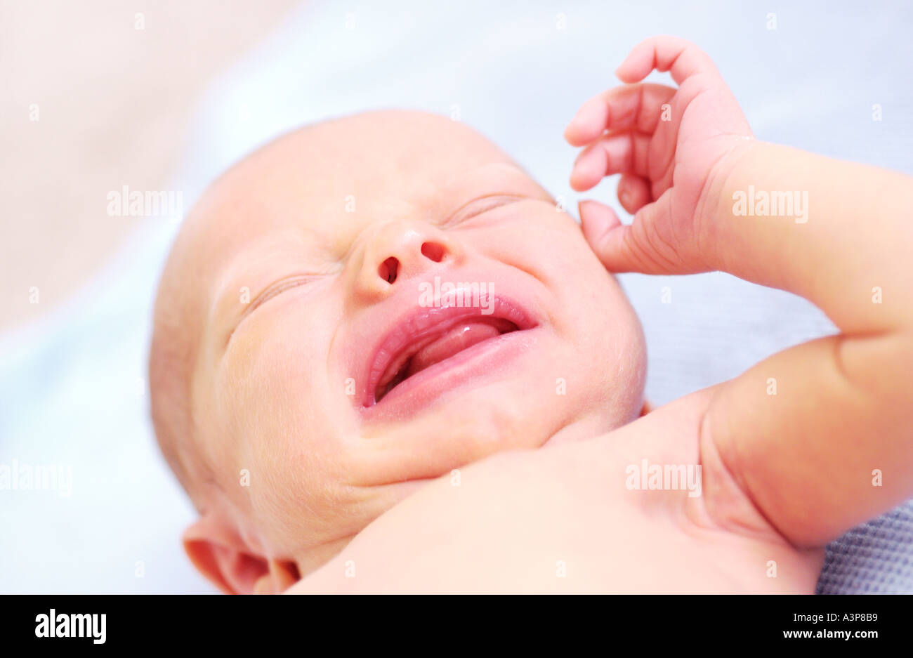 Baby lying in crib crying Stock Photo - Alamy