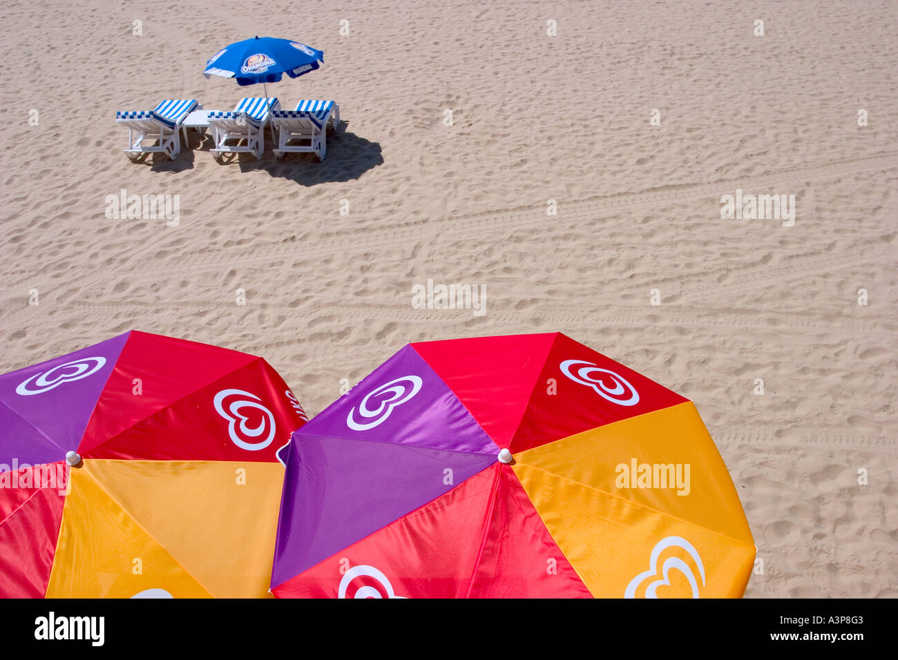 people on a white sandy beach sun tanning and enjoying themselves under ...