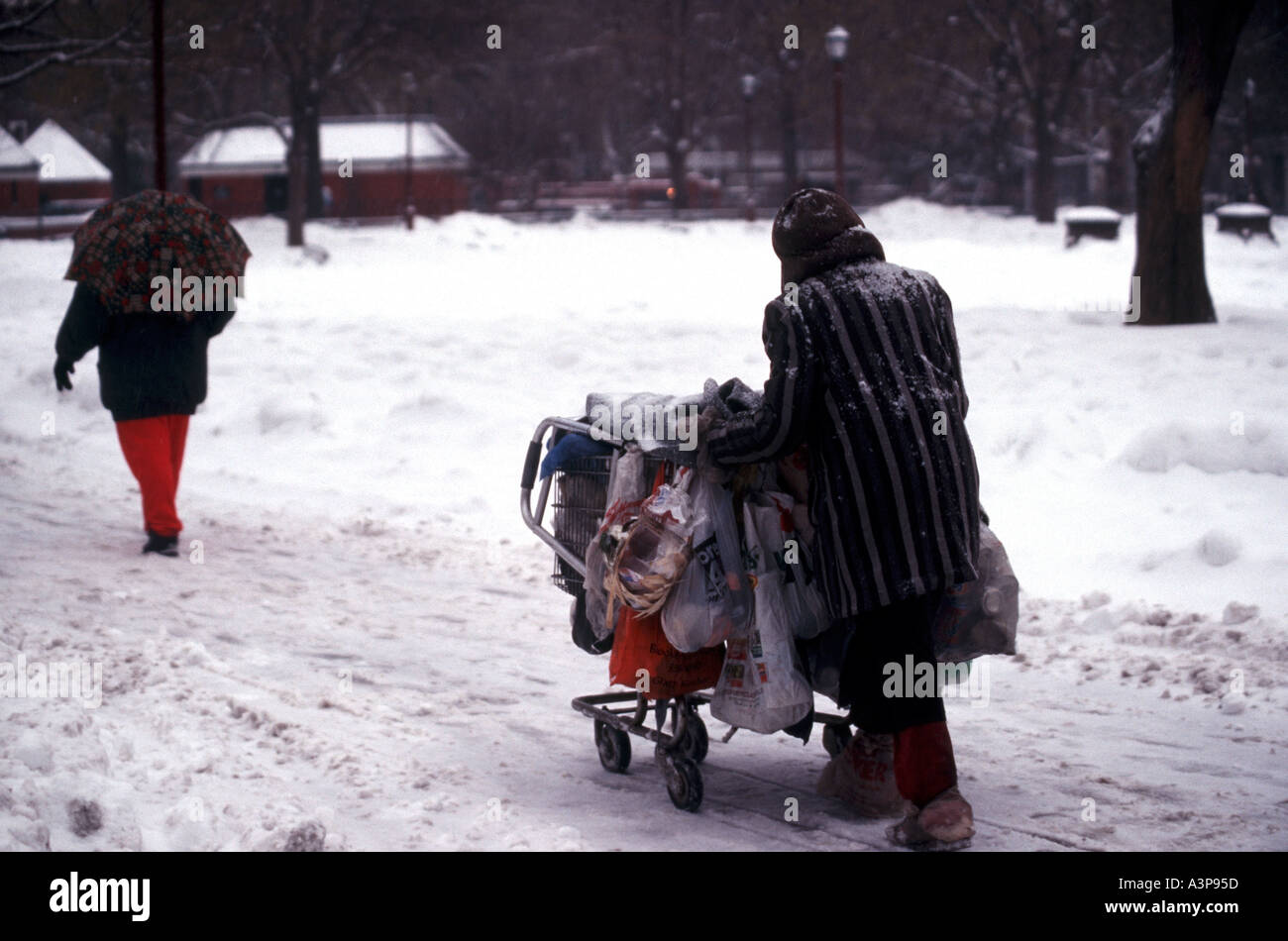 A homeless person walks through Washington Square Park with their ...