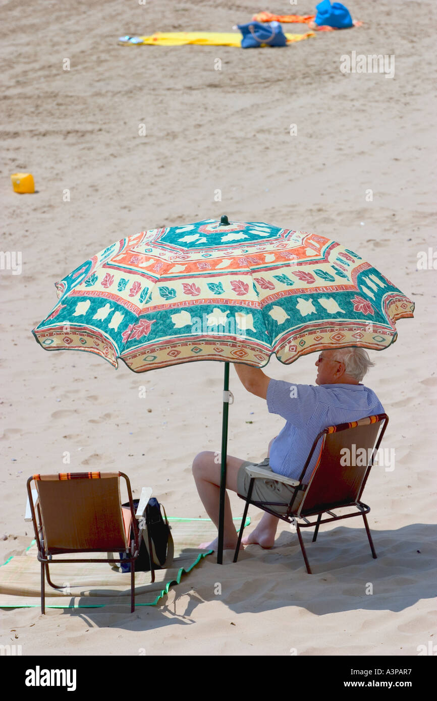 people on a white sandy beach sun tanning and enjoying themselves under ...