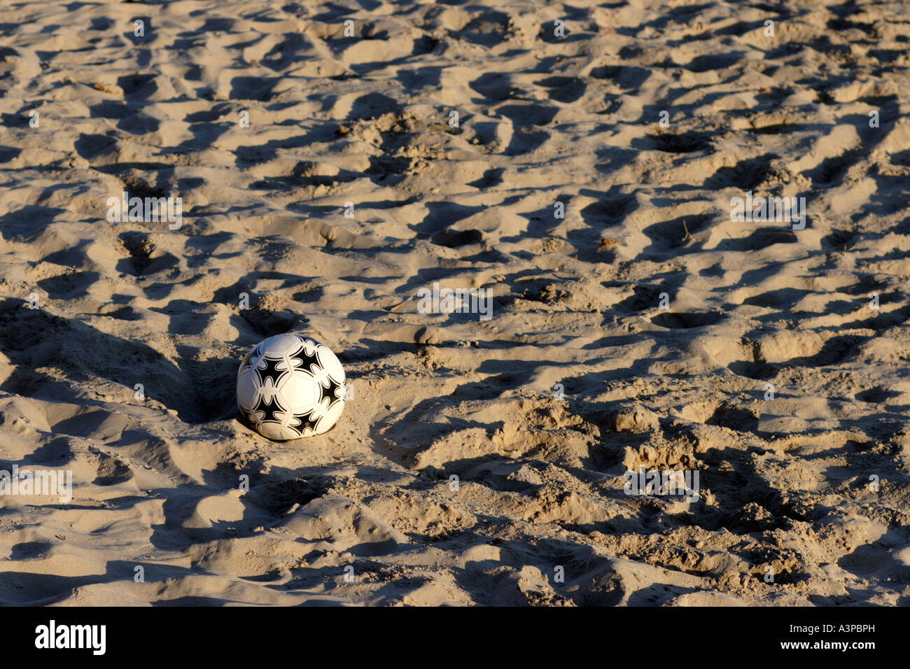 Football lying on sand beach Stock Photo - Alamy