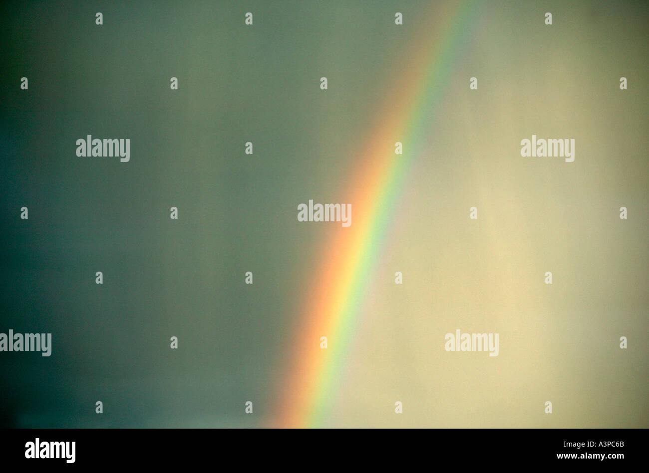 RAINBOW IN STORMY SKY WITH SLANTING RAIN Stock Photo - Alamy