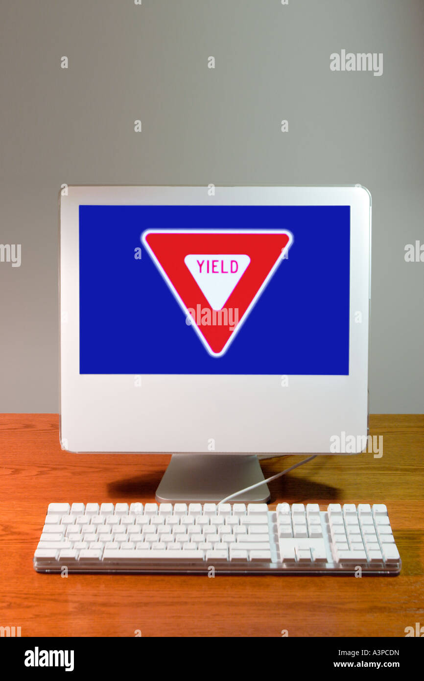 Apple computer with yield sign on screen Stock Photo - Alamy