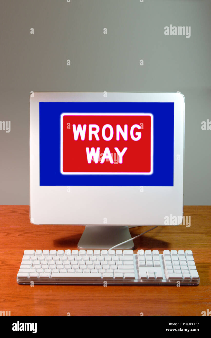 Apple computer with wrong way sign on screen Stock Photo - Alamy