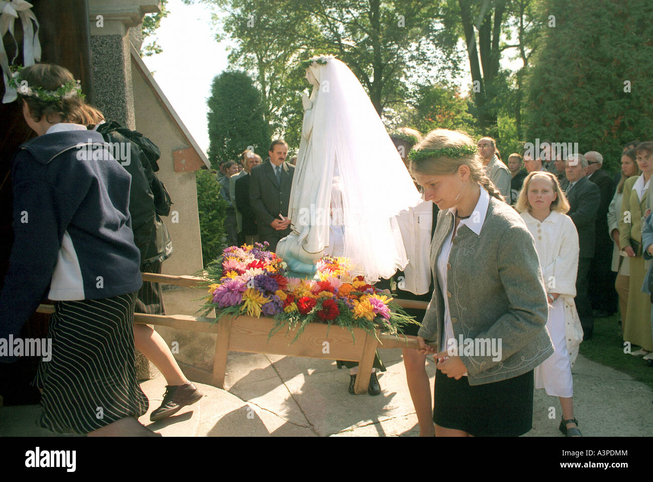 Girls carrying a statue of Virgin Mary at a procession, Poland Stock ...