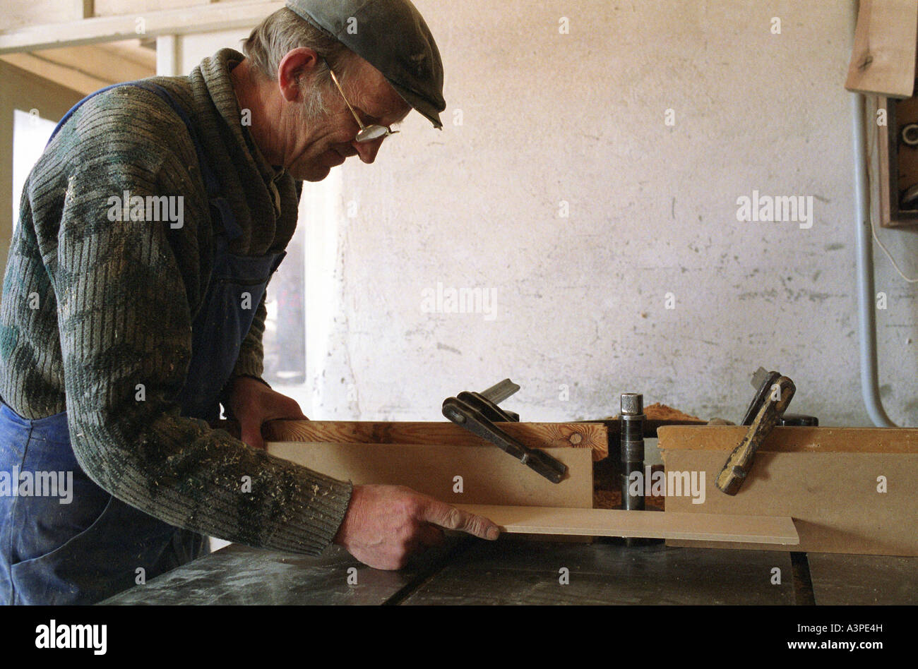 An elderly carpenter at work, Poland Stock Photo - Alamy