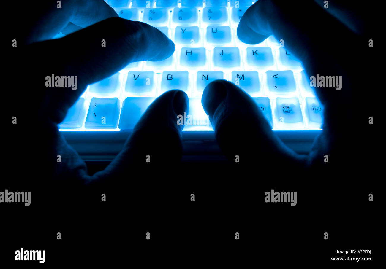 hands typing on blue backlit keyboard Stock Photo - Alamy