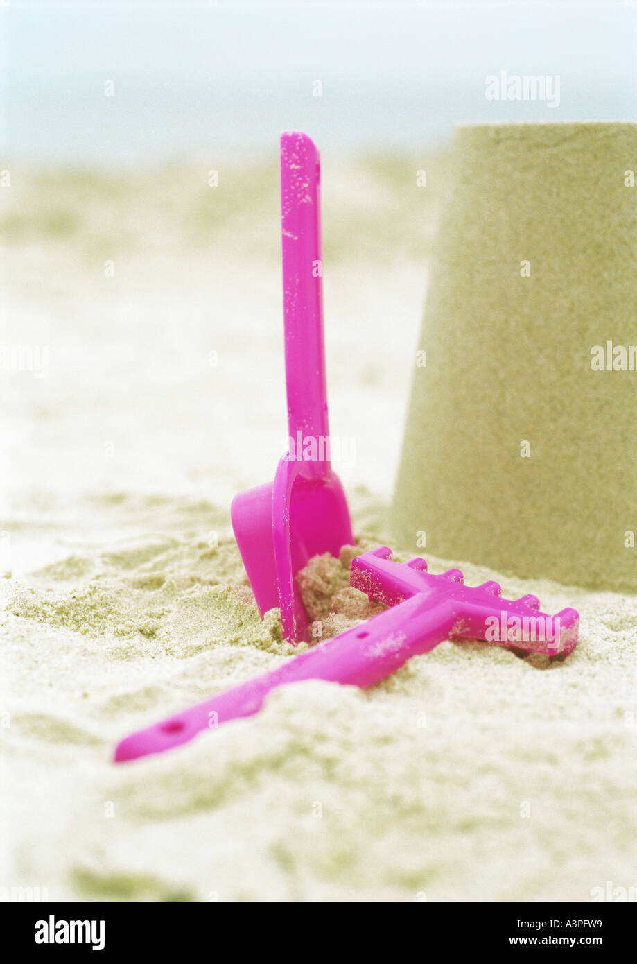 Sand shovel and rake on beach Stock Photo - Alamy