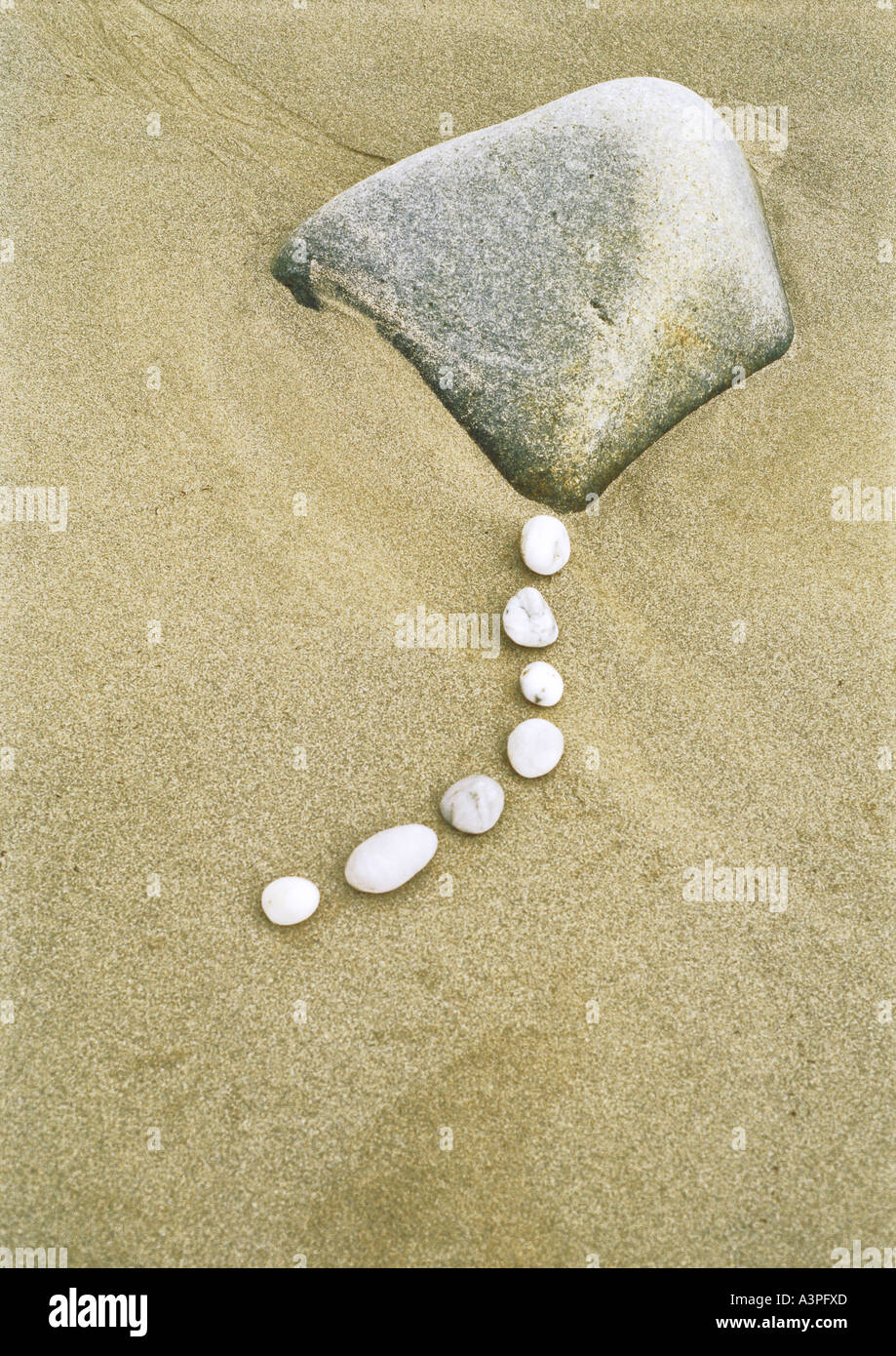 Line of pebbles and rock on beach Stock Photo - Alamy