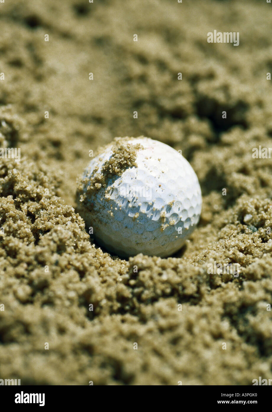 Golf ball in sand trap, close-up Stock Photo - Alamy