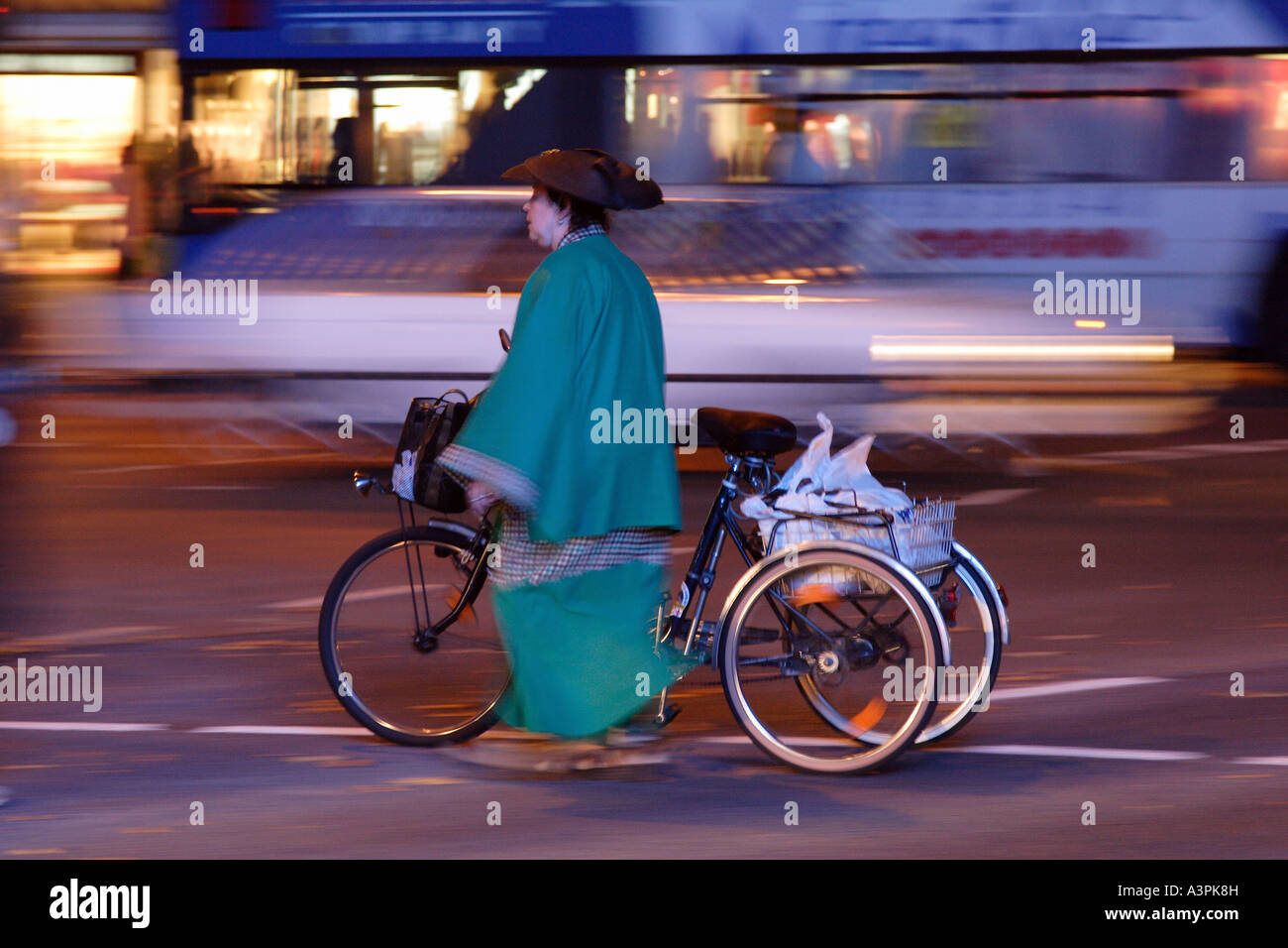 Woman with a bike crossing a street Stock Photo - Alamy