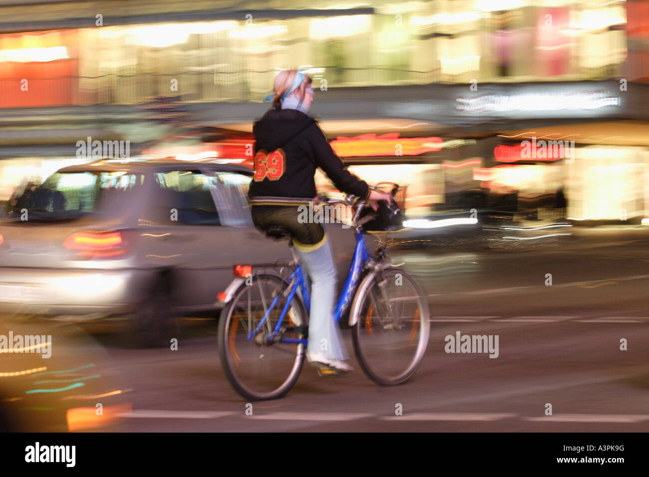 A female bicyclist in street traffic Stock Photo - Alamy