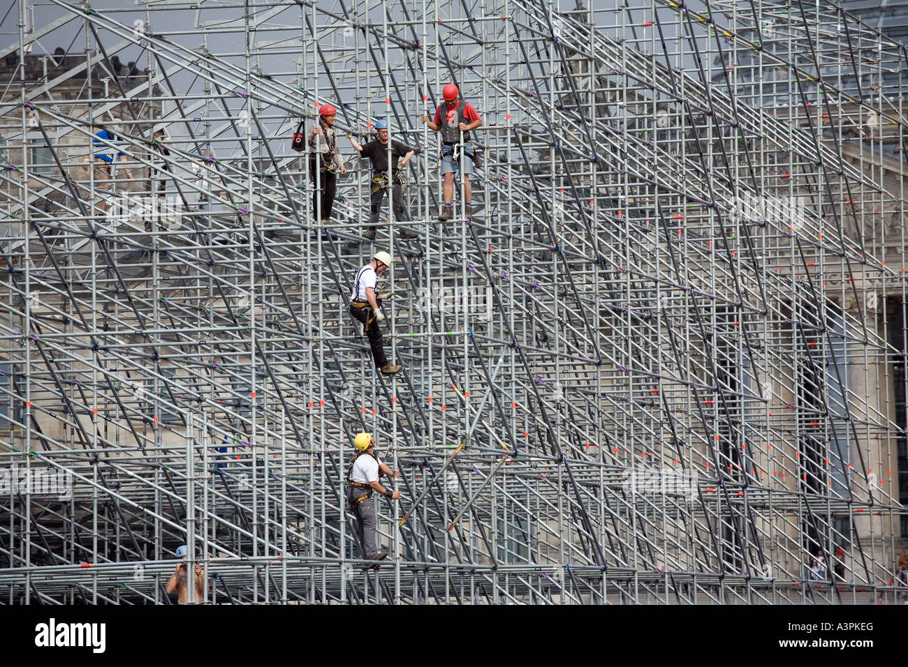 Construction workers on a scaffolding Stock Photo - Alamy