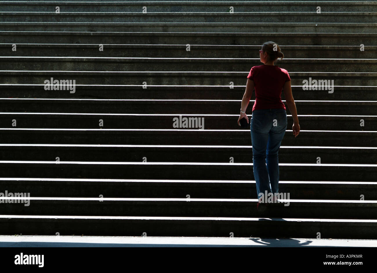 A young woman walking up the stairs Stock Photo - Alamy