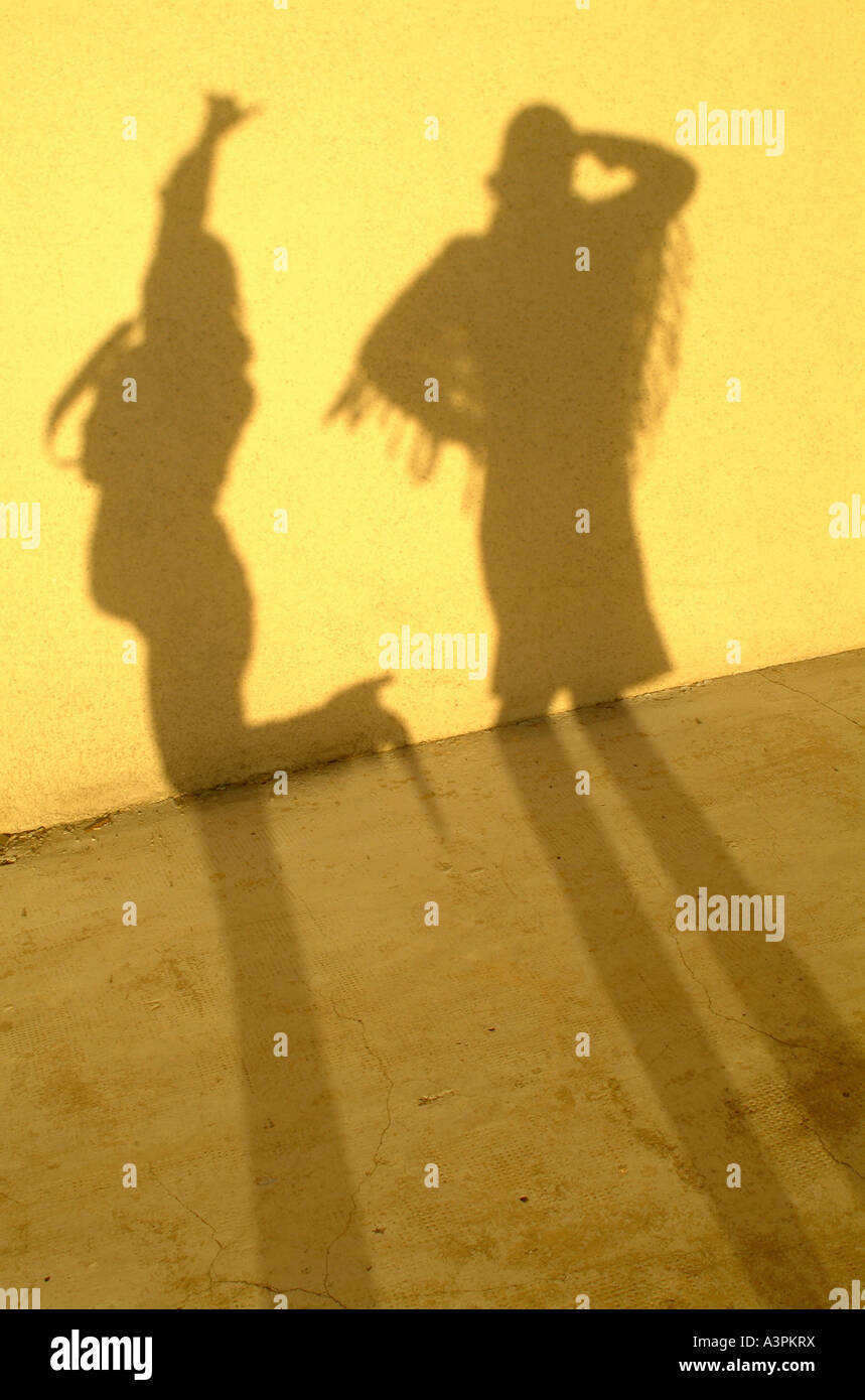 Shadows of two people on yellow wall Stock Photo - Alamy