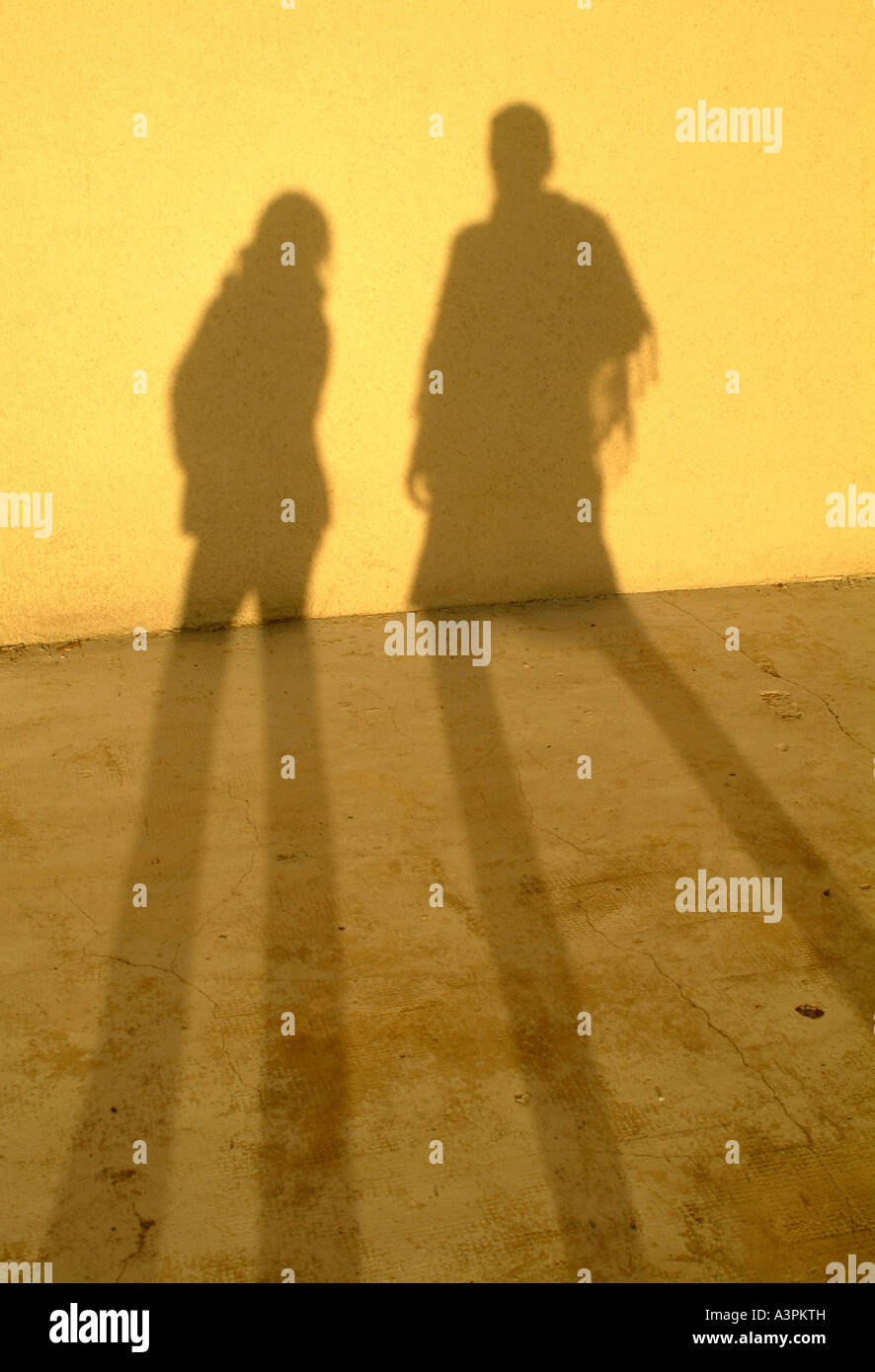 Shadows of two people on yellow wall Stock Photo - Alamy