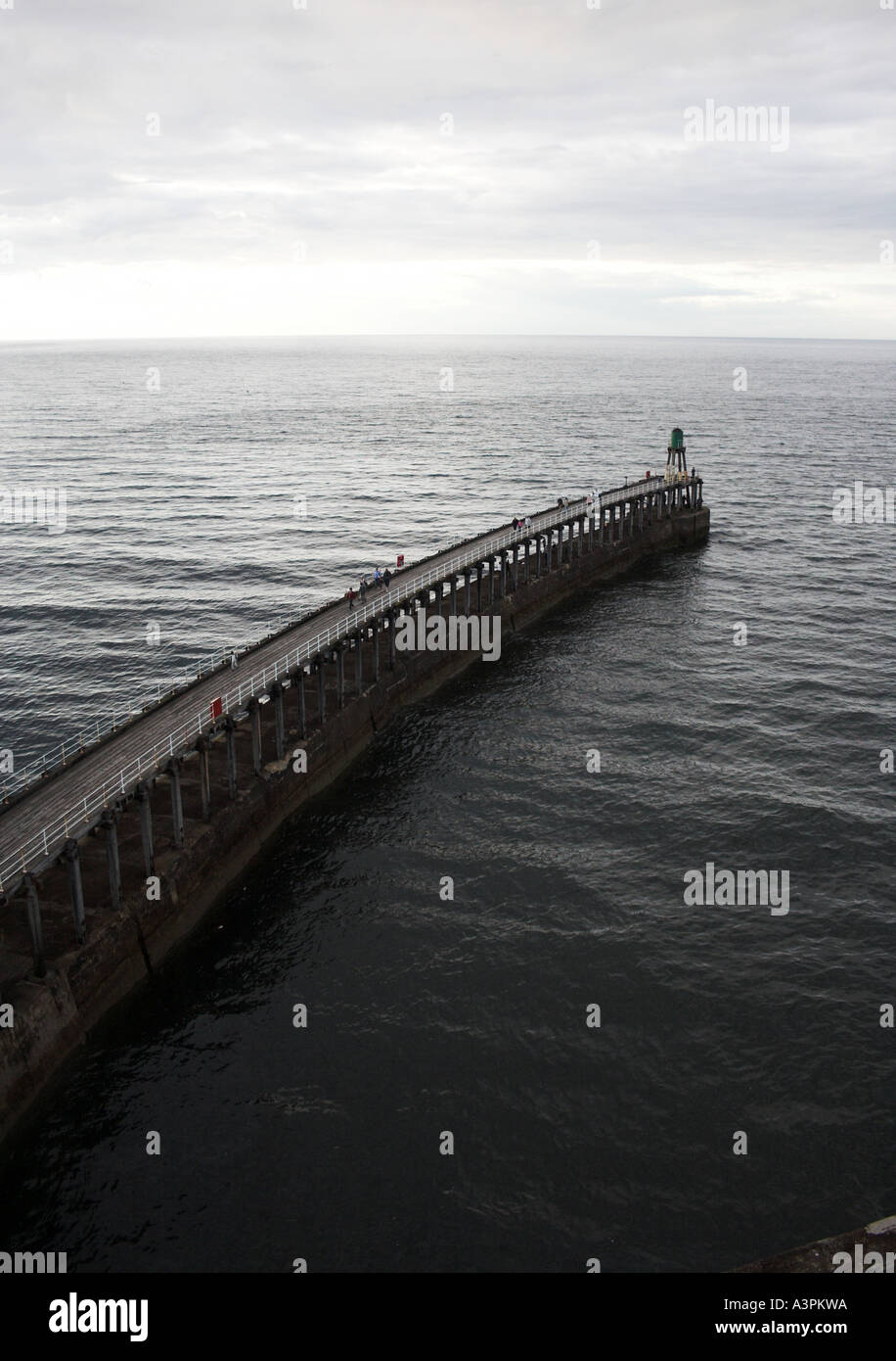 The North Pier at Whitby, seen from the lighthouse, stretching into a ...