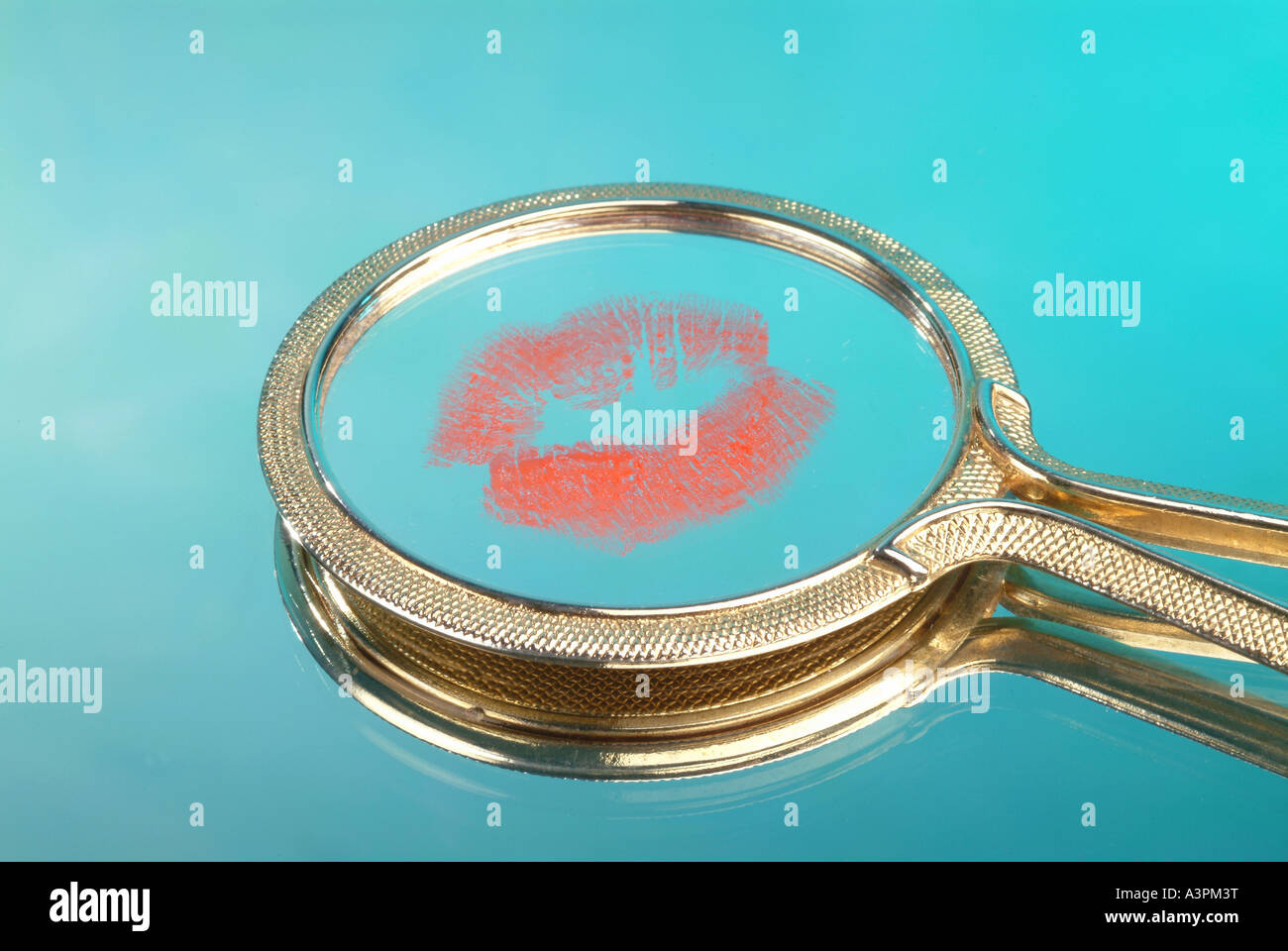Golden hand mirror with a lipstick kiss on it Stock Photo - Alamy