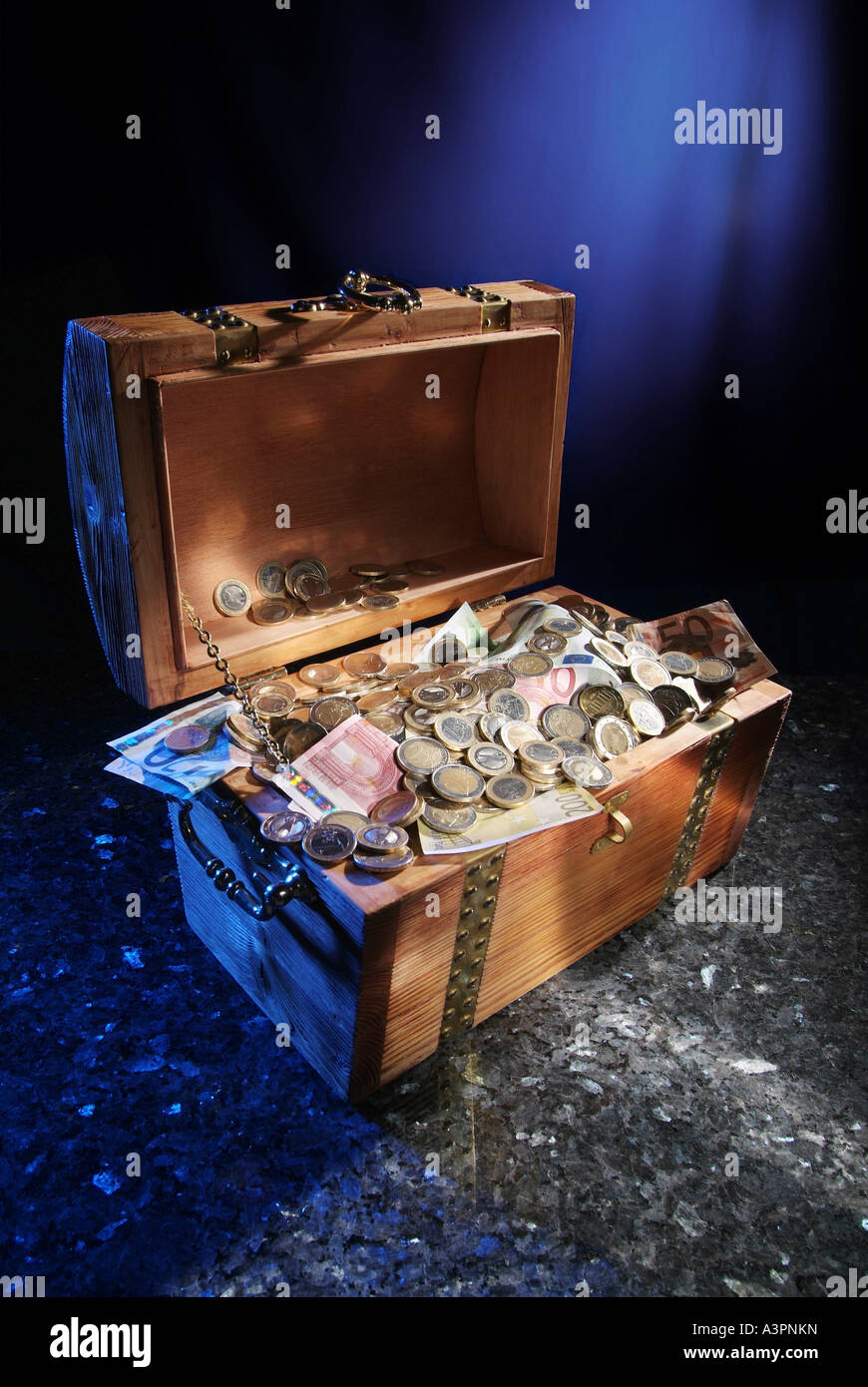 A treasure chest filled with money Stock Photo - Alamy