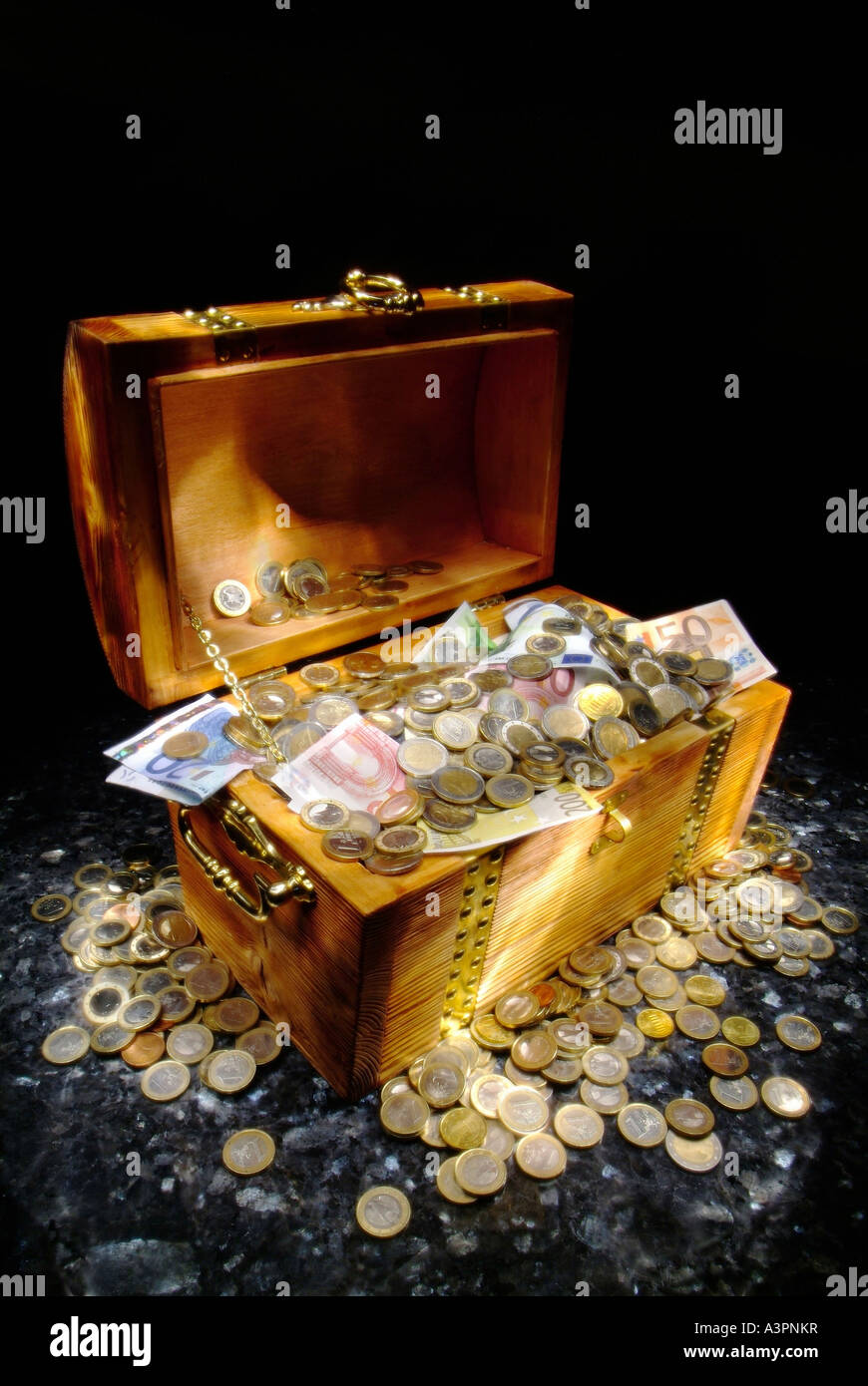 A treasure chest filled with money Stock Photo - Alamy