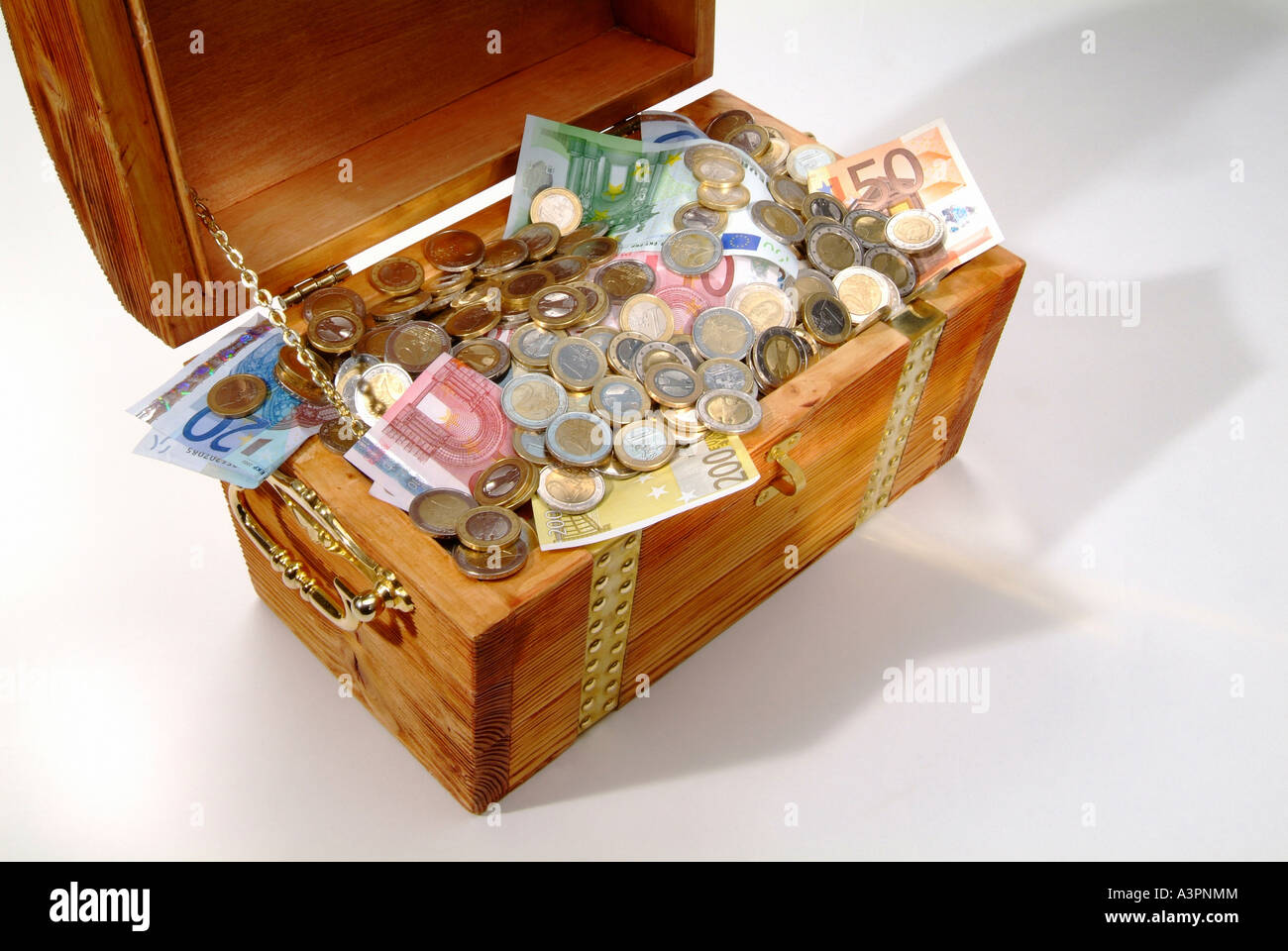 A treasure chest filled with money Stock Photo - Alamy
