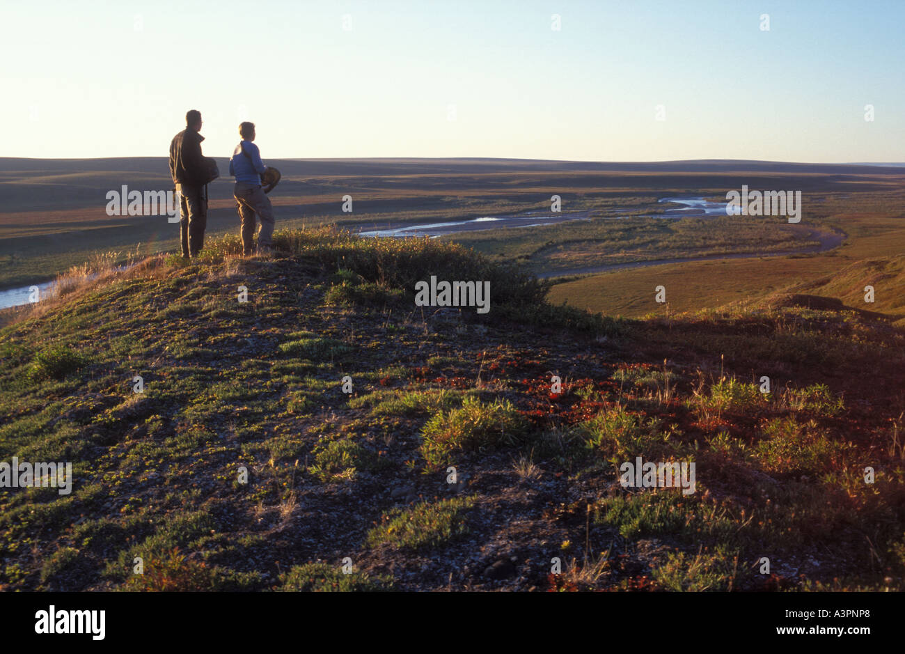 Hikers on hill overlloking Killik River Arctic tundra autumn National ...