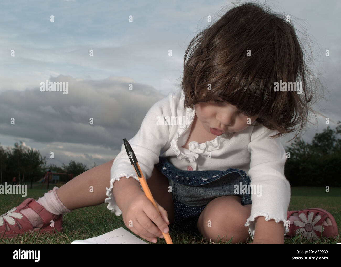 Child writing in the park Stock Photo - Alamy