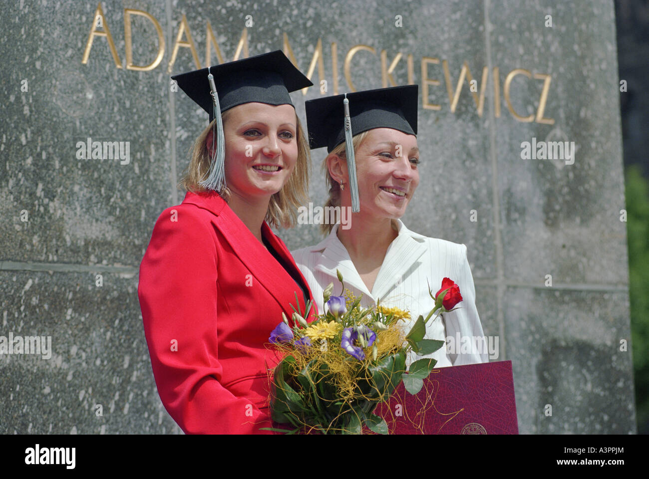 University graduates at the Adam Mickiewicz statue in Poznan, Poland ...