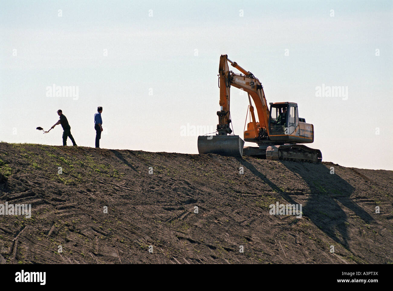 Workmen and an excavator, Wittenburg, Germany Stock Photo - Alamy