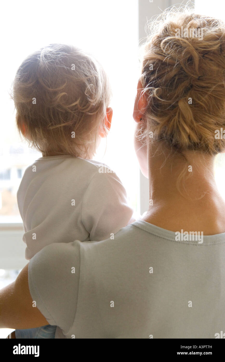 mother baby looking through window Stock Photo - Alamy