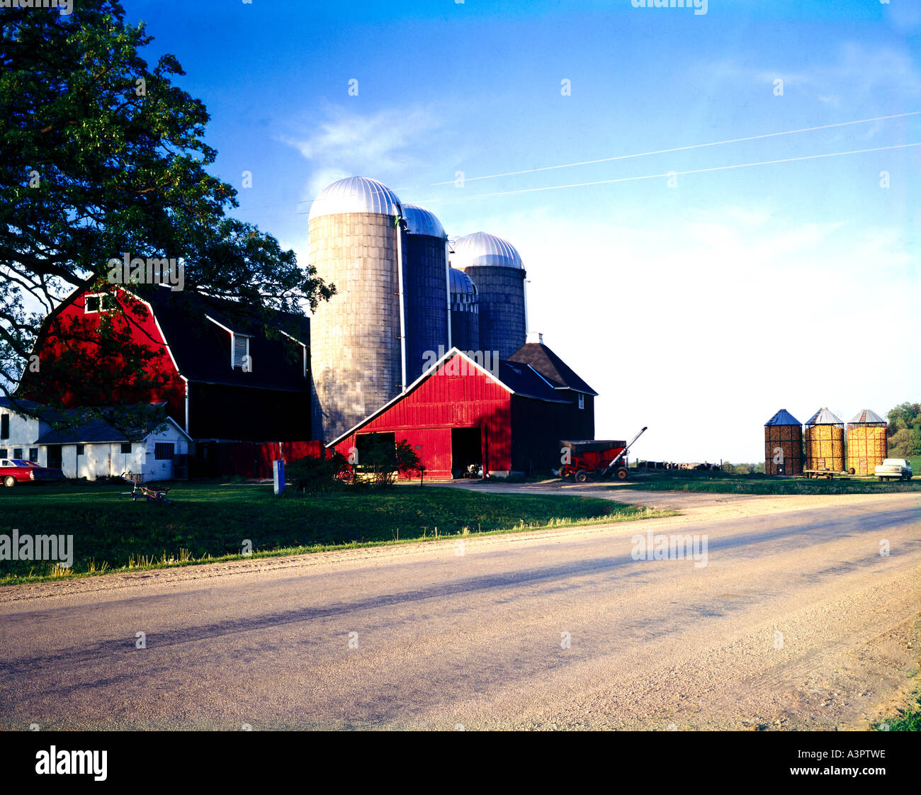 Wisconsin farm with classis red barns, towering silos and storage bins ...