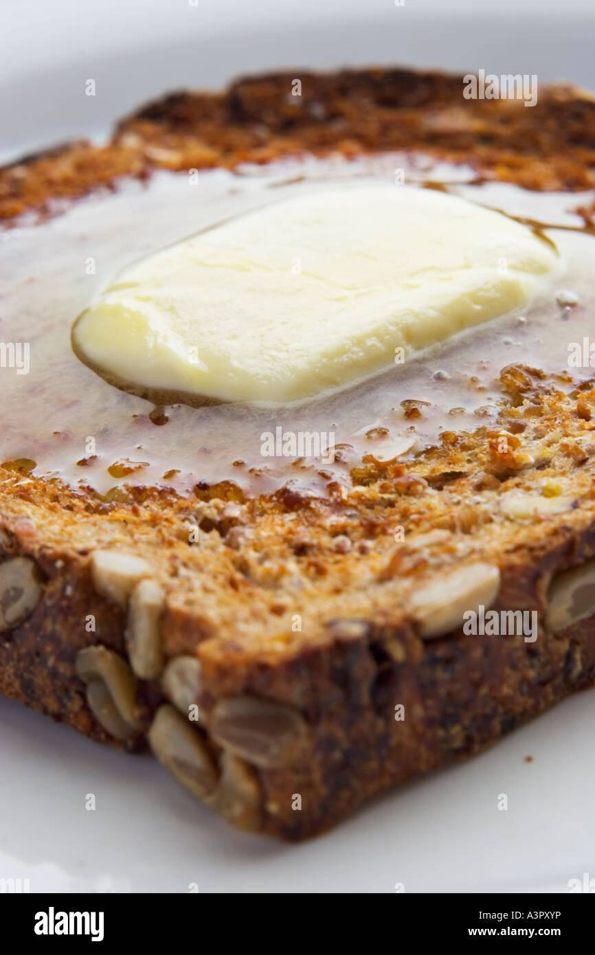 Slice of whole wheat bread toasted with melting butter Stock Photo - Alamy