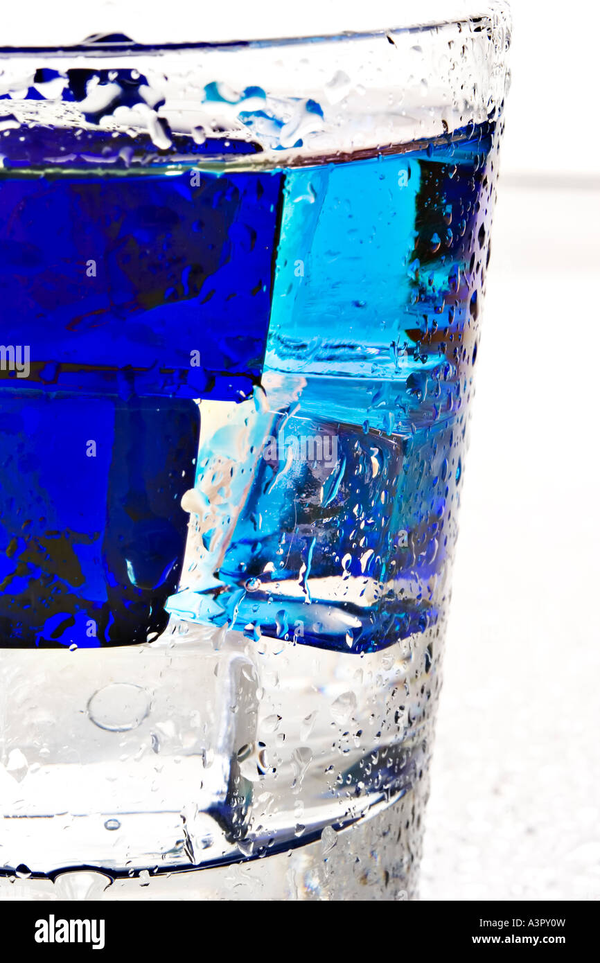 Clear beverage with blue ice cubes Stock Photo - Alamy