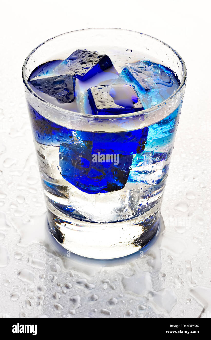 Clear beverage with blue ice cubes Stock Photo - Alamy