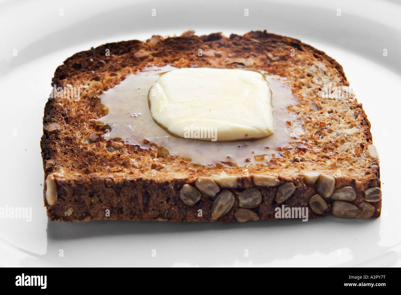 Slice of whole wheat bread toasted with melting butter Stock Photo - Alamy