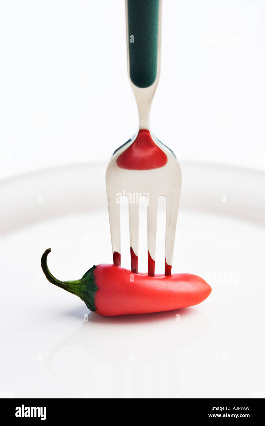 Pepper stuck by a fork Stock Photo - Alamy