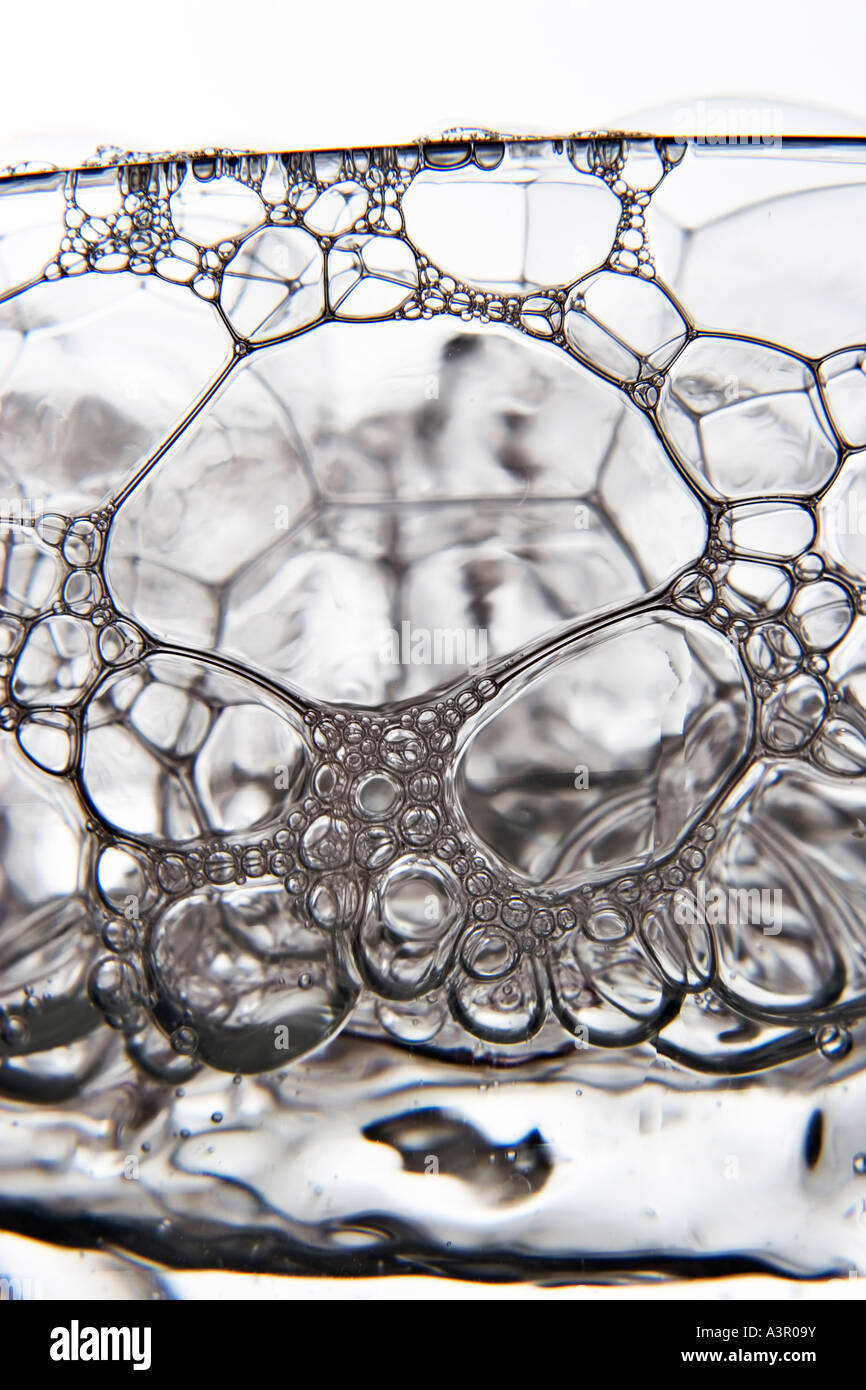 Blowing bubbles through a straw in a glass of water Stock Photo - Alamy