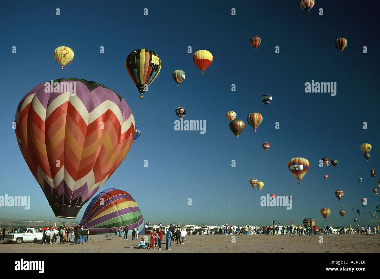 Balloons in the air and some getting ready to launch Stock Photo - Alamy