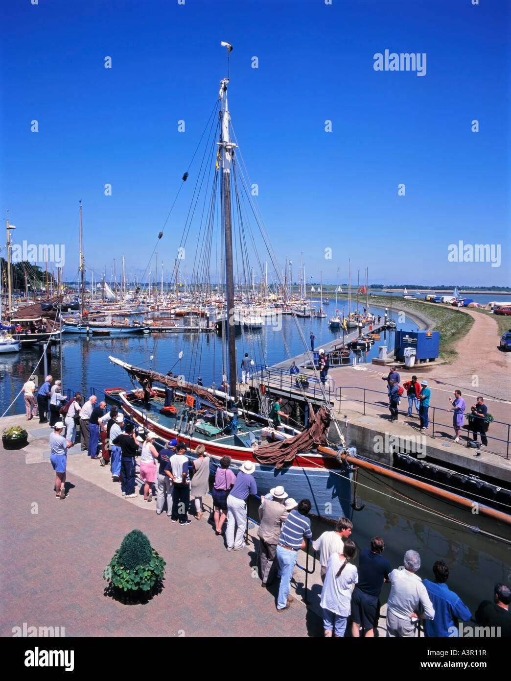 Crowds looking on a Classic Sailing Yacht entering the Locks at Shotley ...