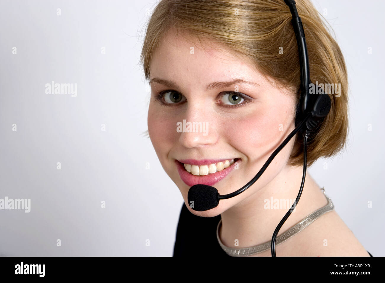 Young attractive woman answering calls on a headphone Stock Photo - Alamy