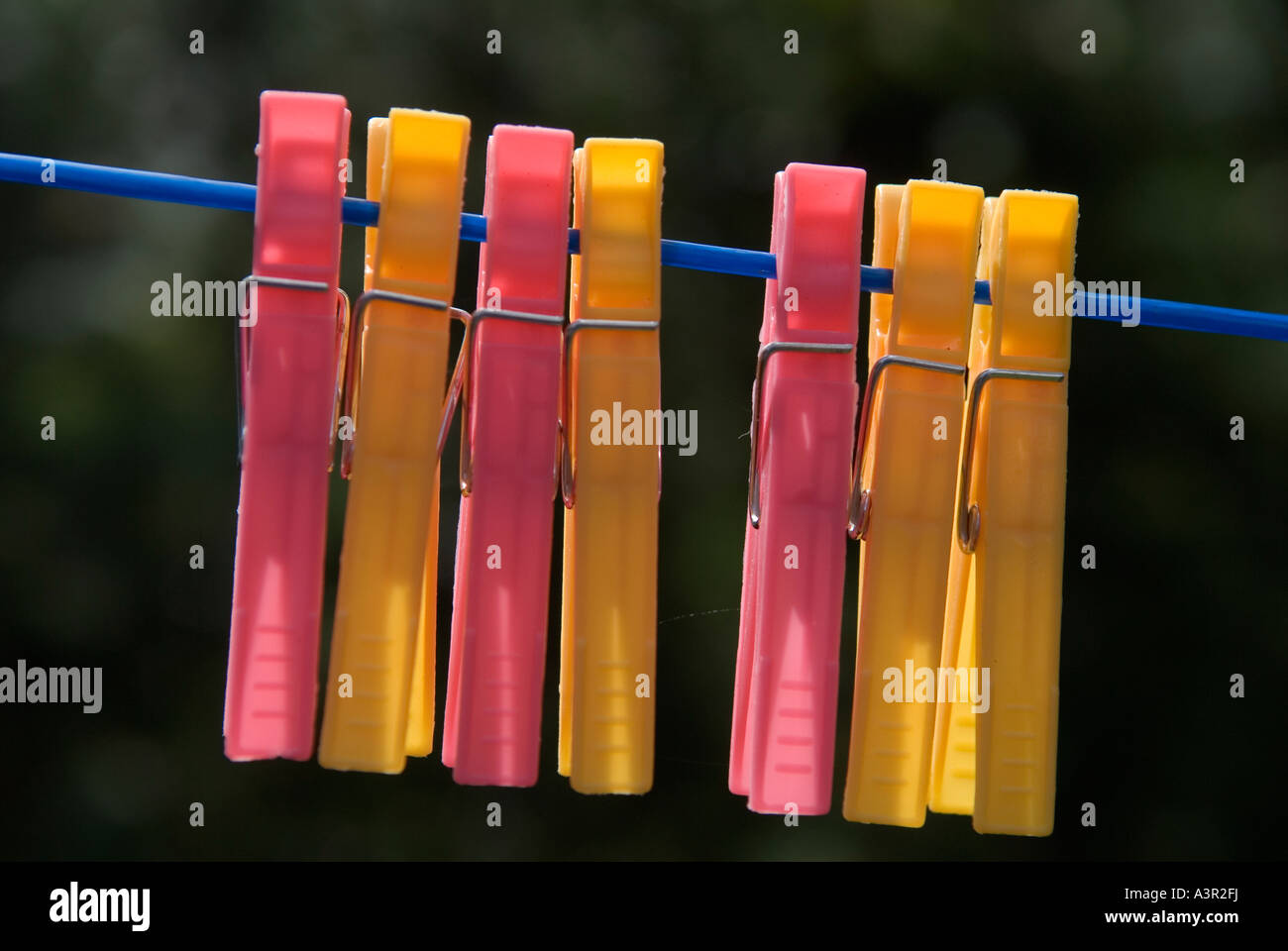 Clothespegs on a clothesline Stock Photo - Alamy