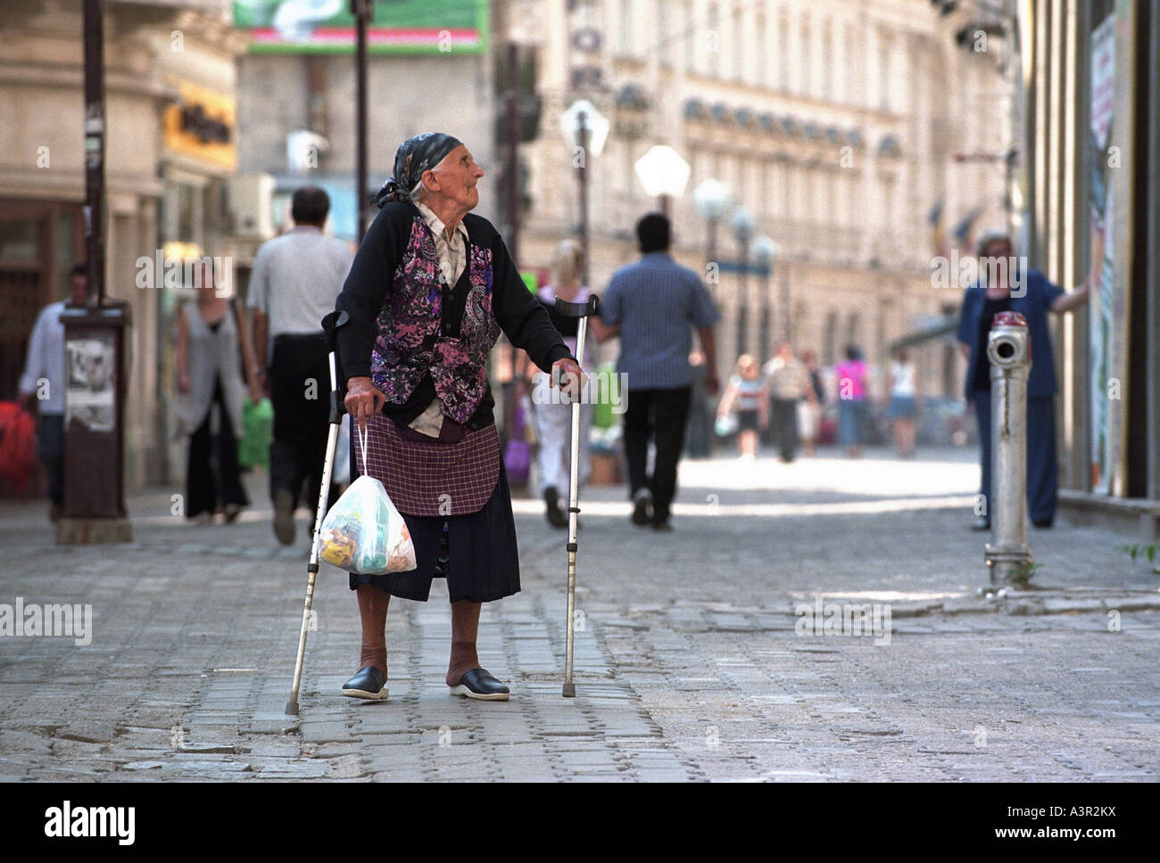 Old woman at a pedestrian boulevard in Bucharest, Romania Stock Photo ...
